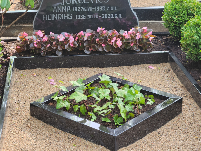 Open granite gravestones for urns in the shape of a diamond